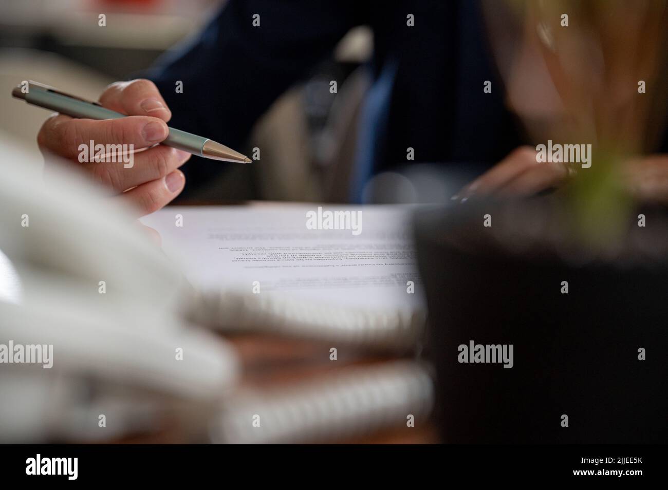 Low angle view of a businesswoman proofreading a contract or ...
