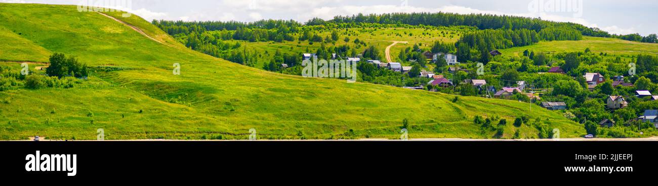 Landscape view of green grass on a hillside with blue sky in the ...