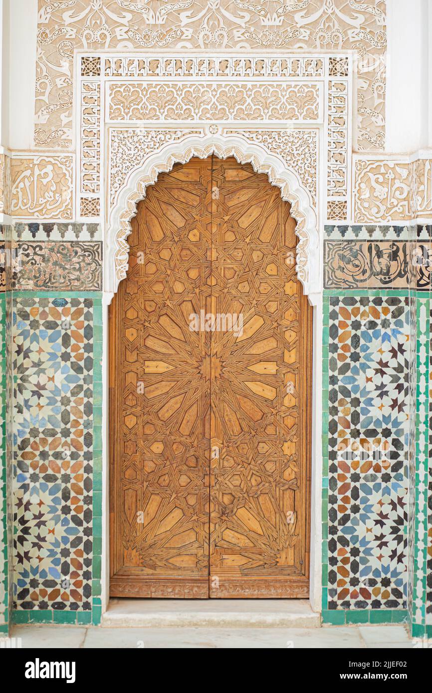 Old Arabian style gate entrance with a wooden closed door in Marrakesh ...