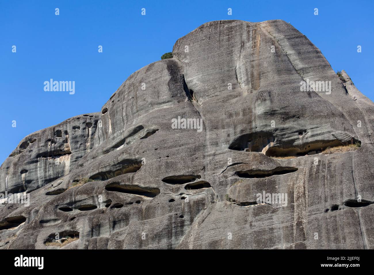 the natural caves for monks in the rock formations of Meteora, Greece ...