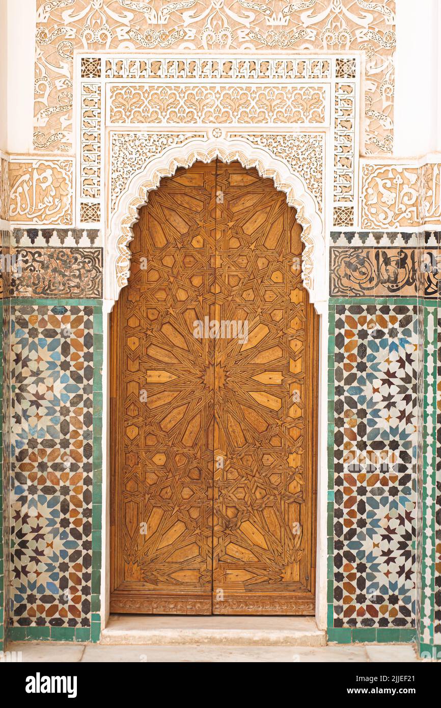 Old Arabian style gate entrance with a wooden closed door in Marrakesh ...