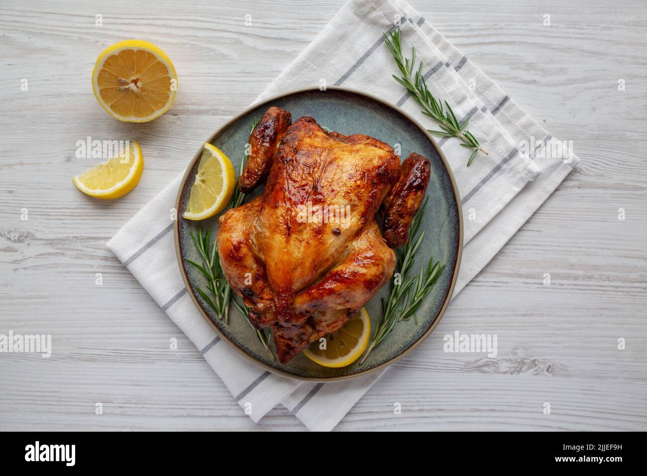 Homemade Lemon and Herb Rotisserie Chicken on a Plate, top view. Flat ...