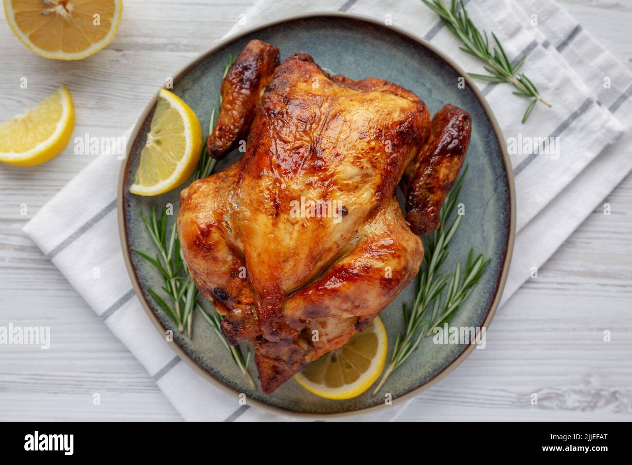 Homemade Lemon and Herb Rotisserie Chicken on a Plate, top view. Flat ...