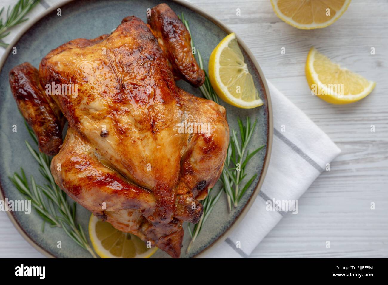 Homemade Lemon and Herb Rotisserie Chicken on a Plate, top view. Flat ...