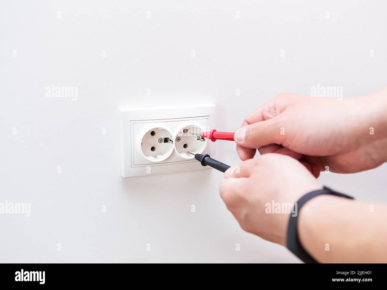 Measuring the voltage in the socket with a professional digital multimeter. Profession ...