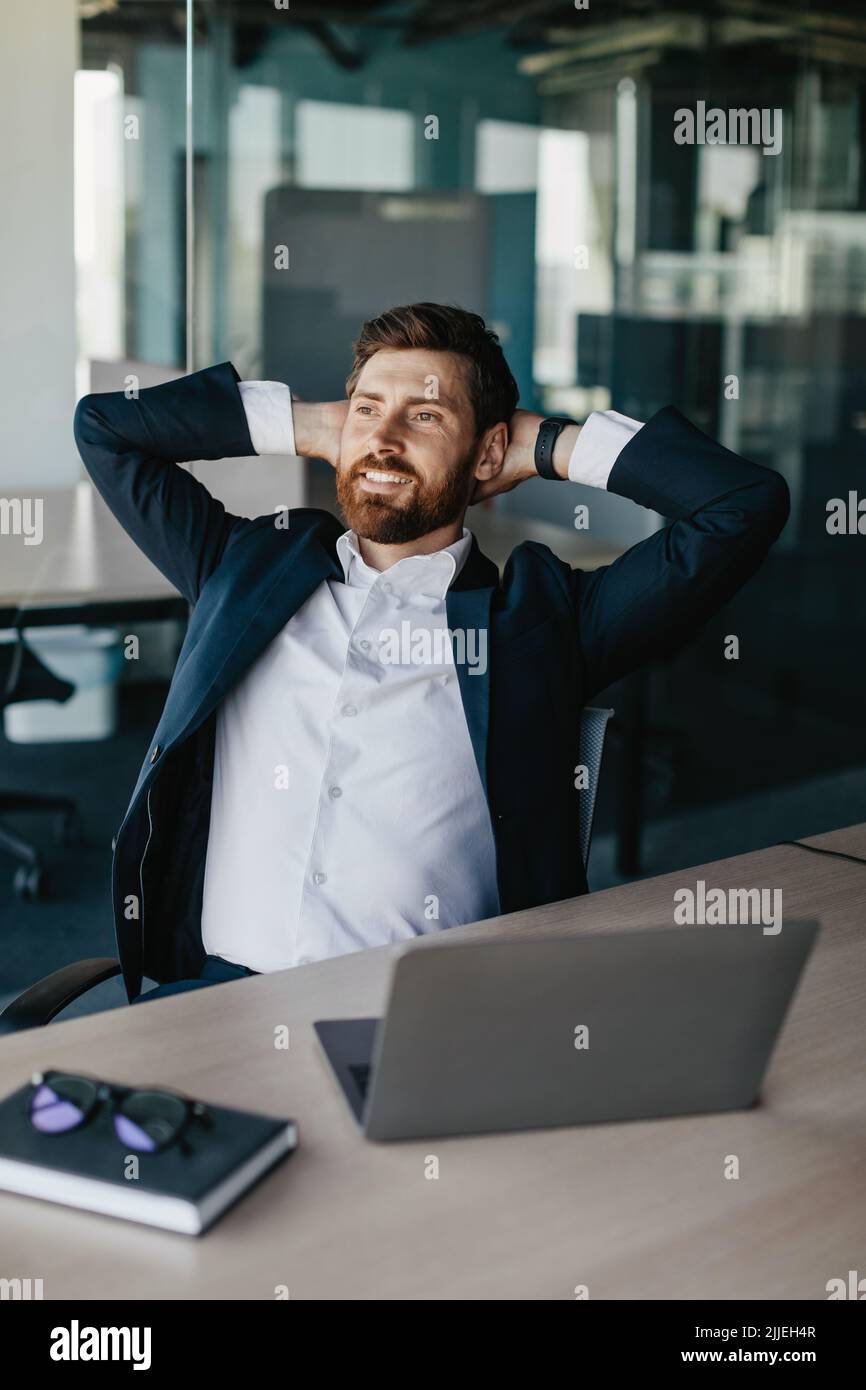 Taking break from work. Excited businessman relaxing on chair, leaning ...