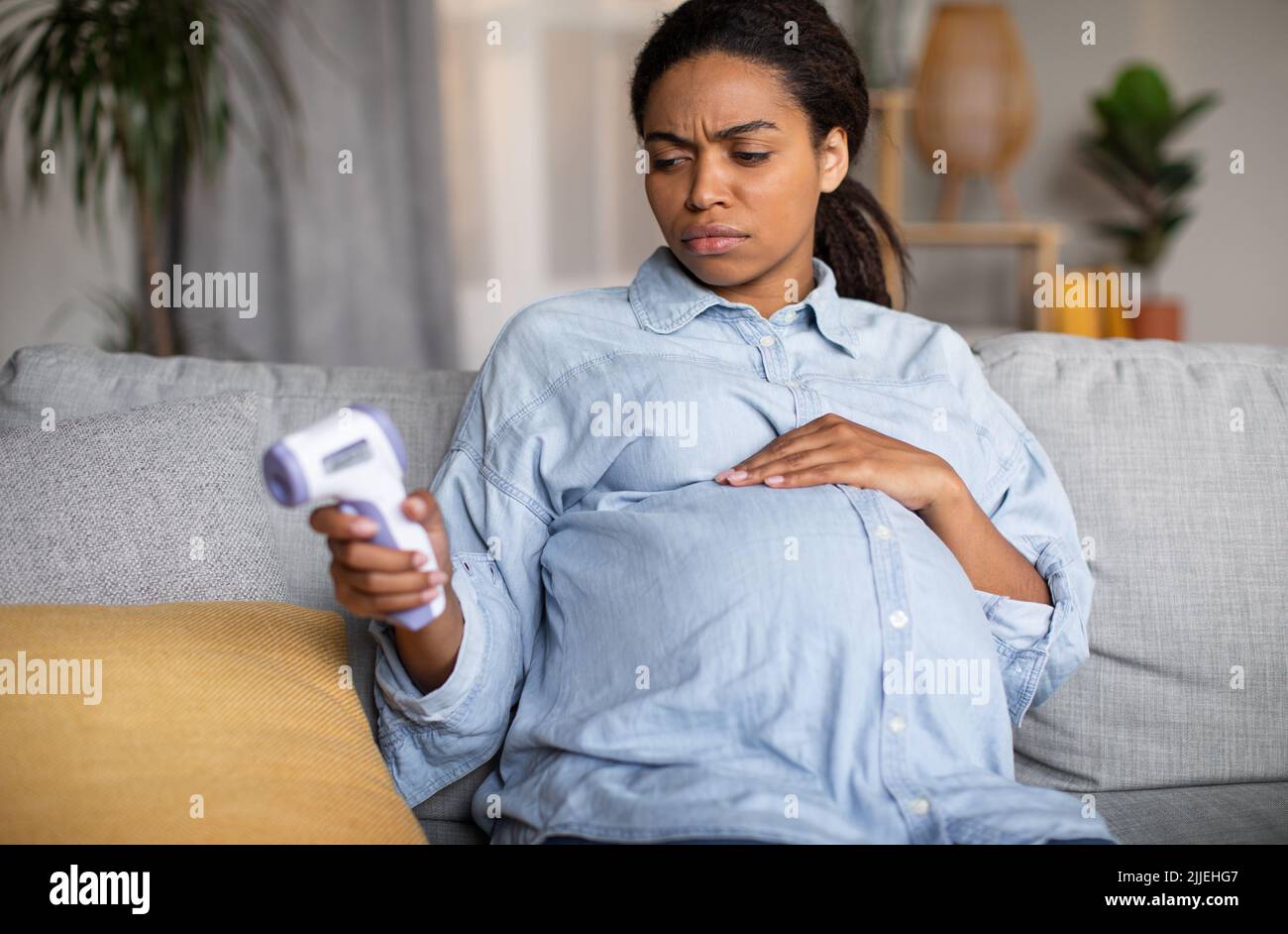 Sick Pregnant Black Lady Having Fever Holding Thermometer At Home Stock ...