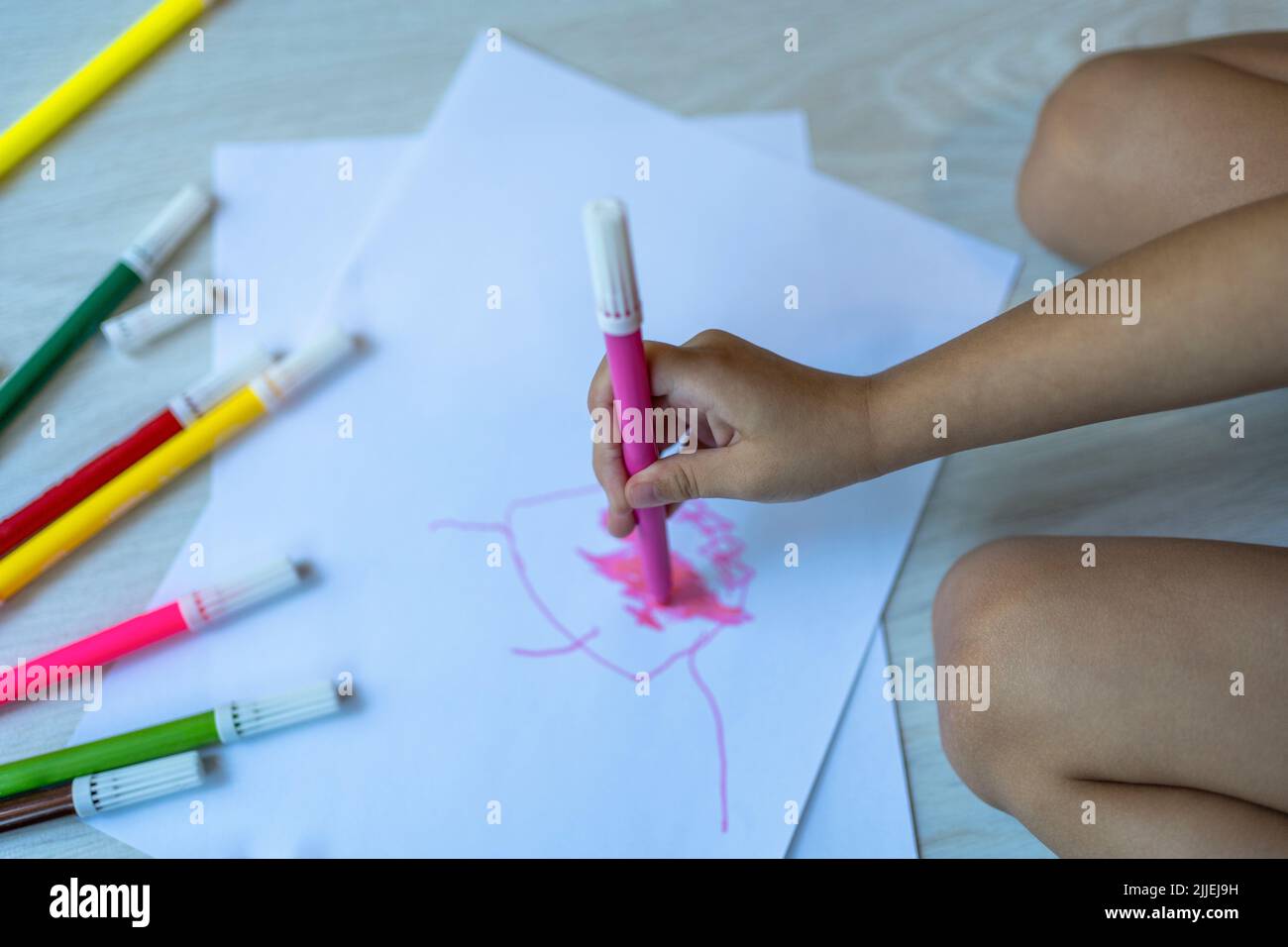girl's hand making a drawing with colours at home Stock Photo - Alamy