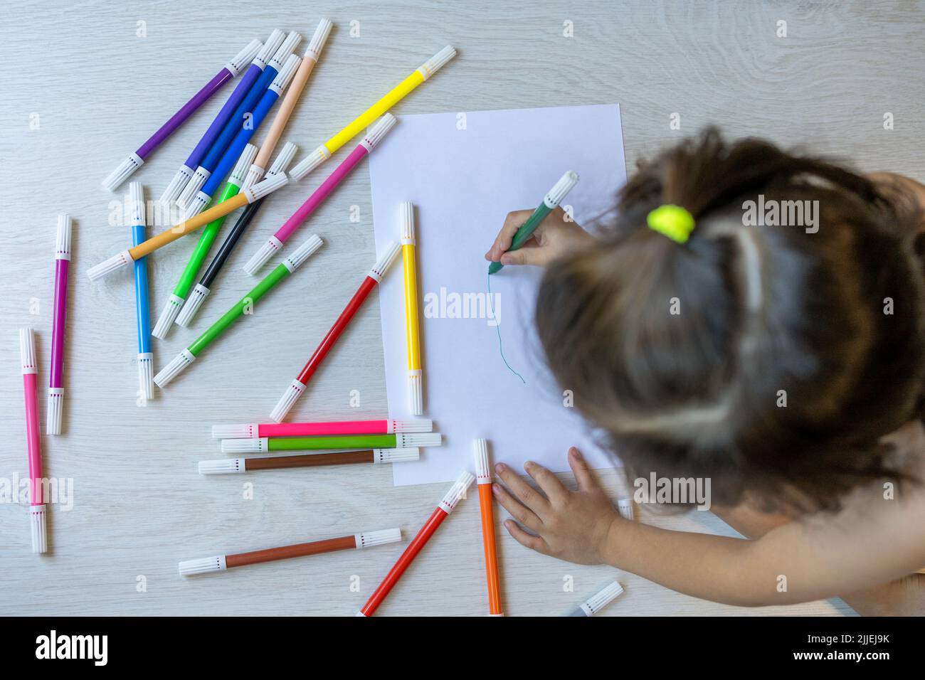 top view of little girl drawing on the floor Stock Photo - Alamy