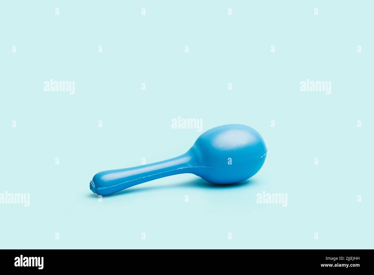 A blue maraca on a light blue background with copy space Stock Photo ...