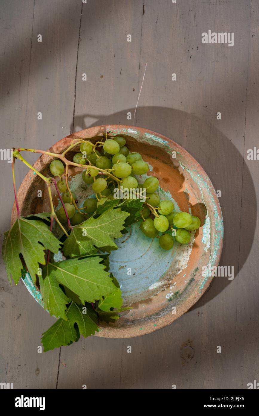 green grapes in rustic clay pot Stock Photo - Alamy