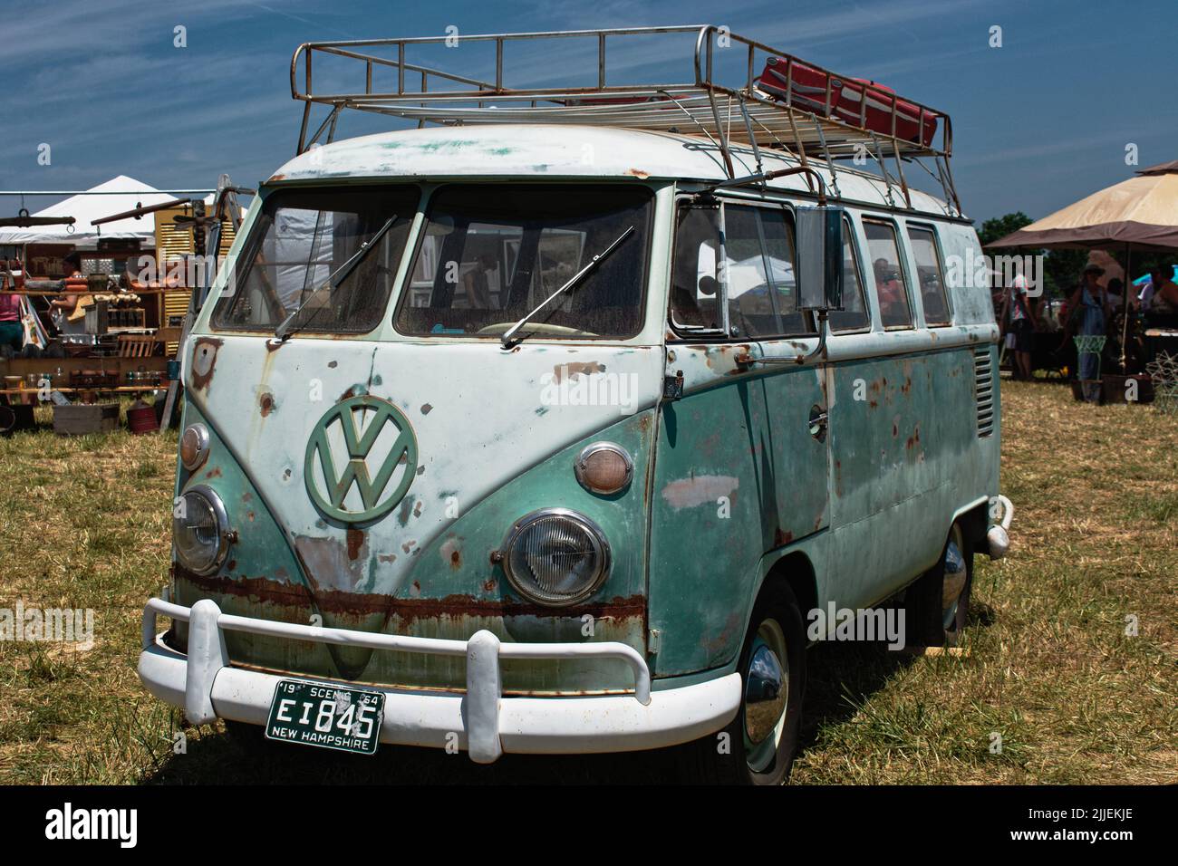 1964 standard Volkswagen Bus and VW beetle-bug parked in a field at ...