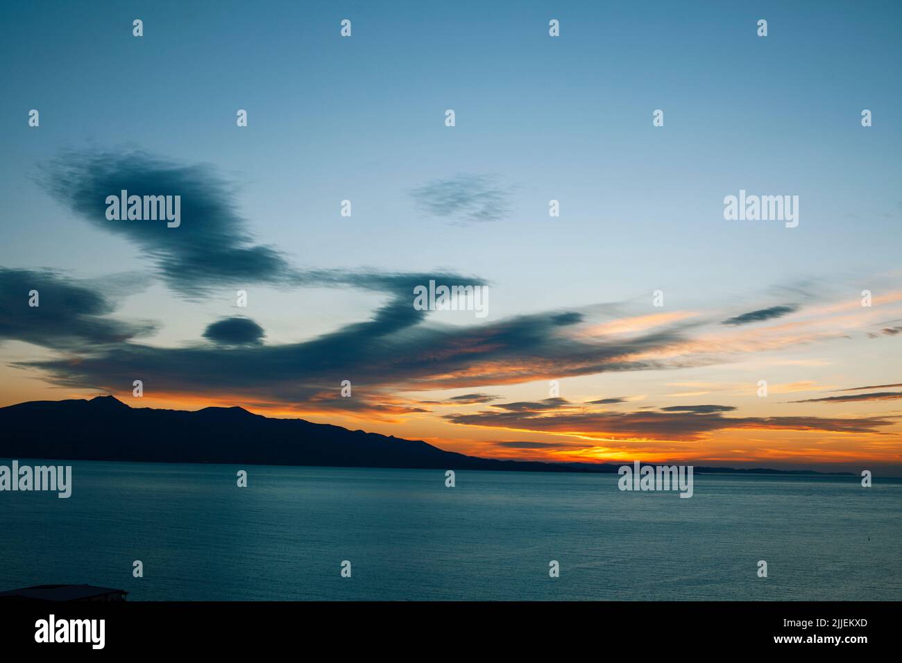 beautiful landscape on sea with sunset, dramatic clouds with red fire ...