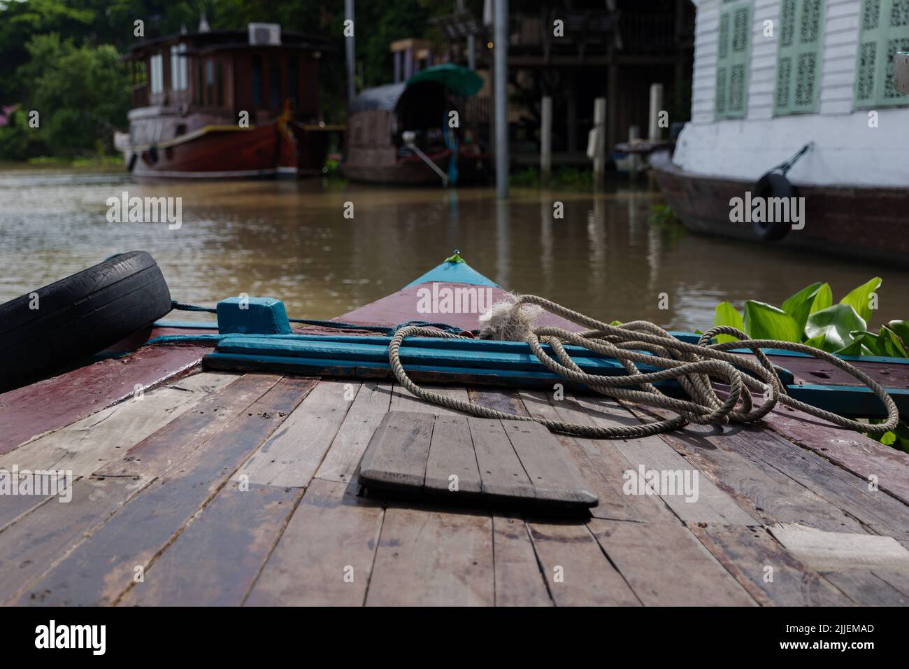 Low angle sunny view at the bow, front of the boat, with wooden floor ...