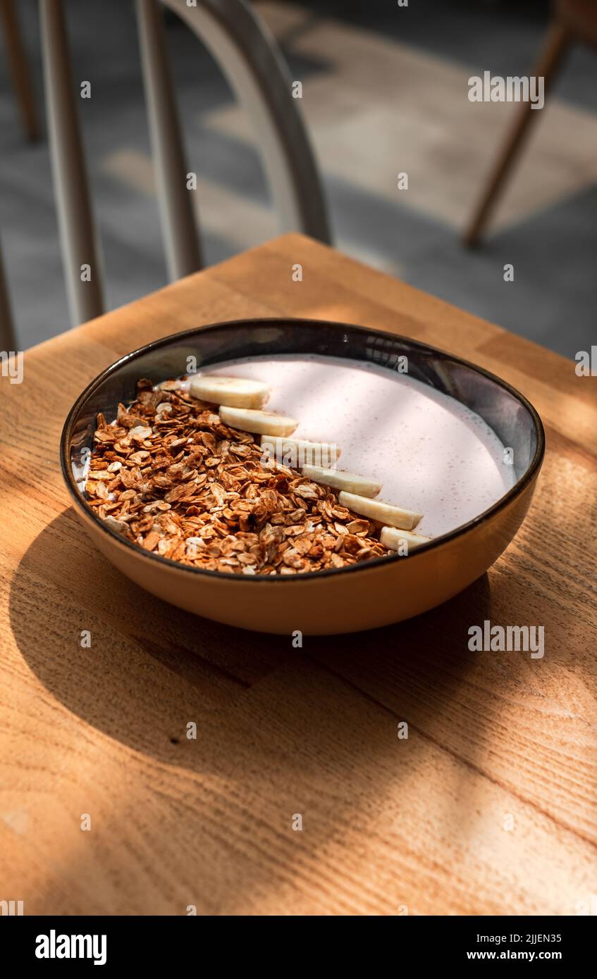 A vertical shot of a breakfast bowl with cereal and bananas Stock Photo ...