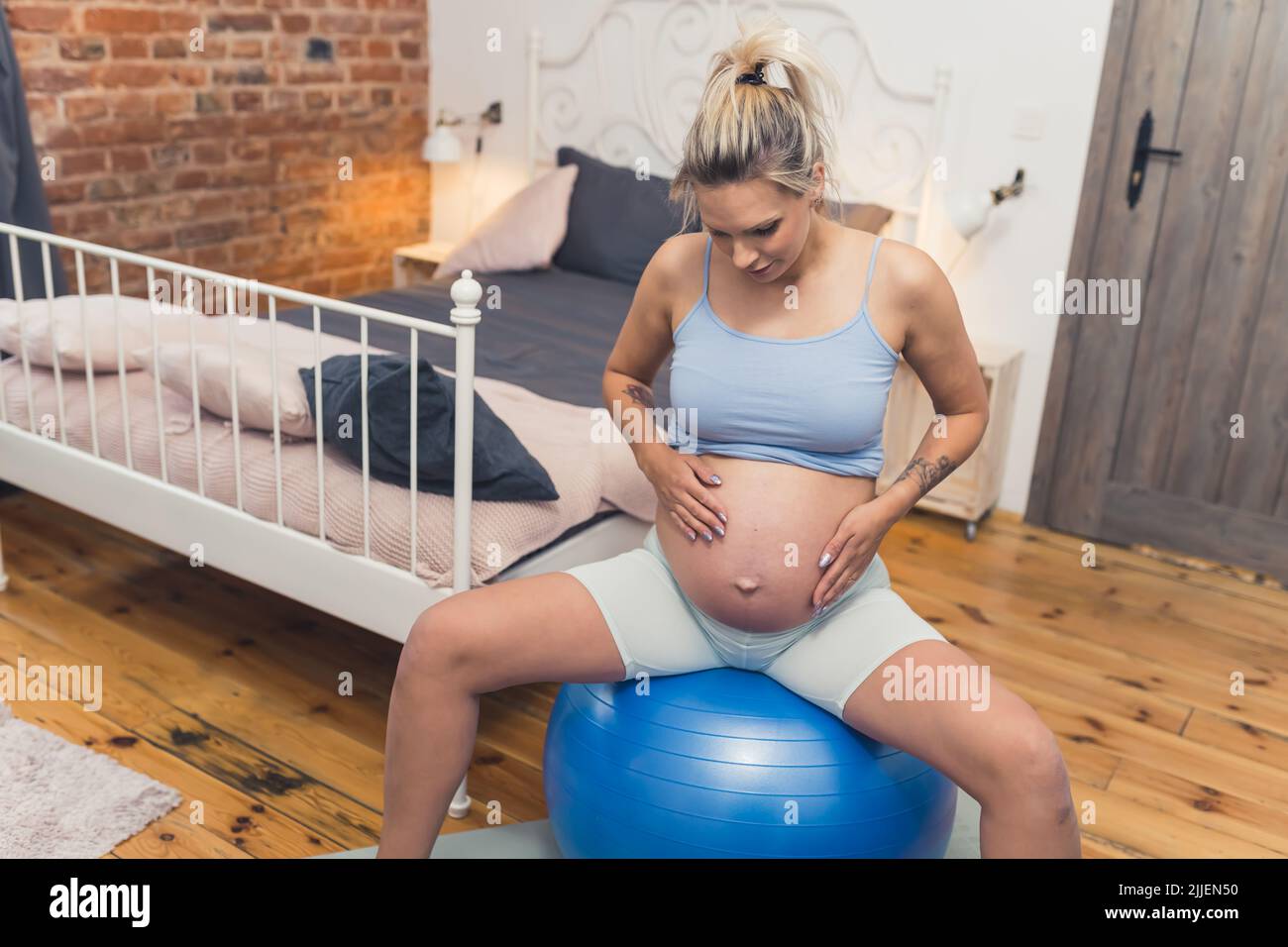 young pregnant woman sitting on a fit ball at home, pregnancy concept. High quality photo Stock ...