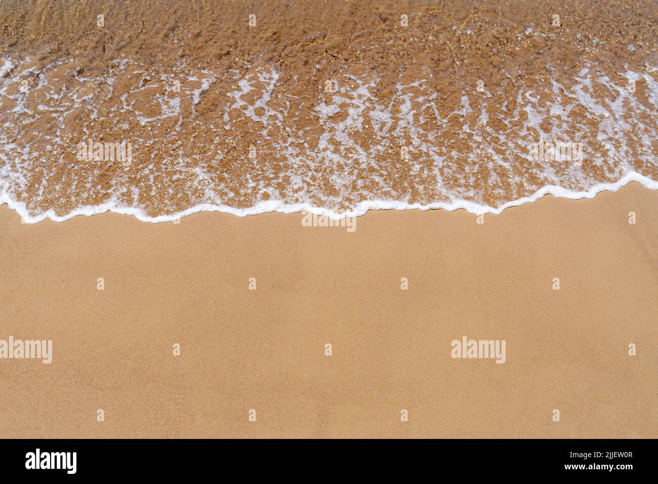 Top view photo of beach sand and ripples with bubbles Stock Photo - Alamy
