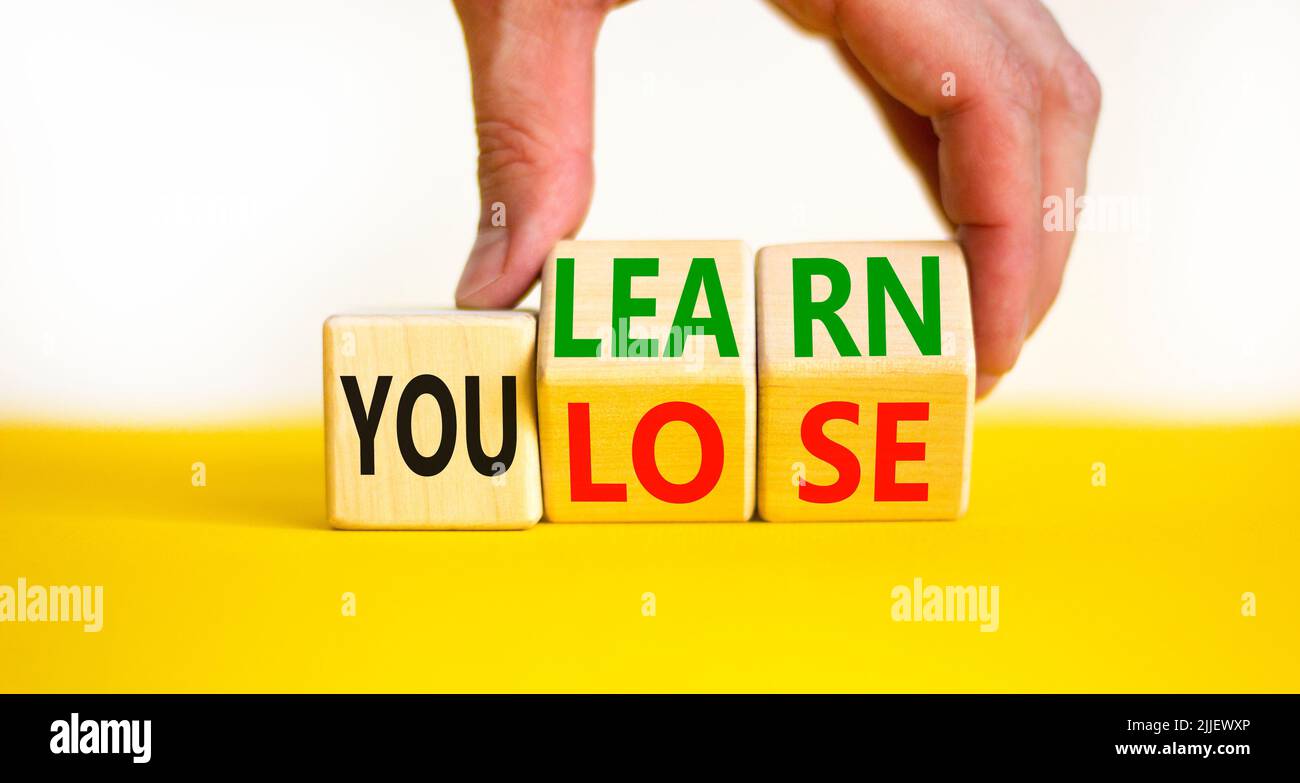 We learn or lose symbol. Concept words We learn and We lose on wooden ...