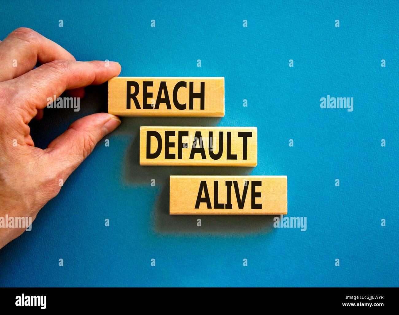 Reach default alive symbol. Concept words Reach default alive on wooden ...
