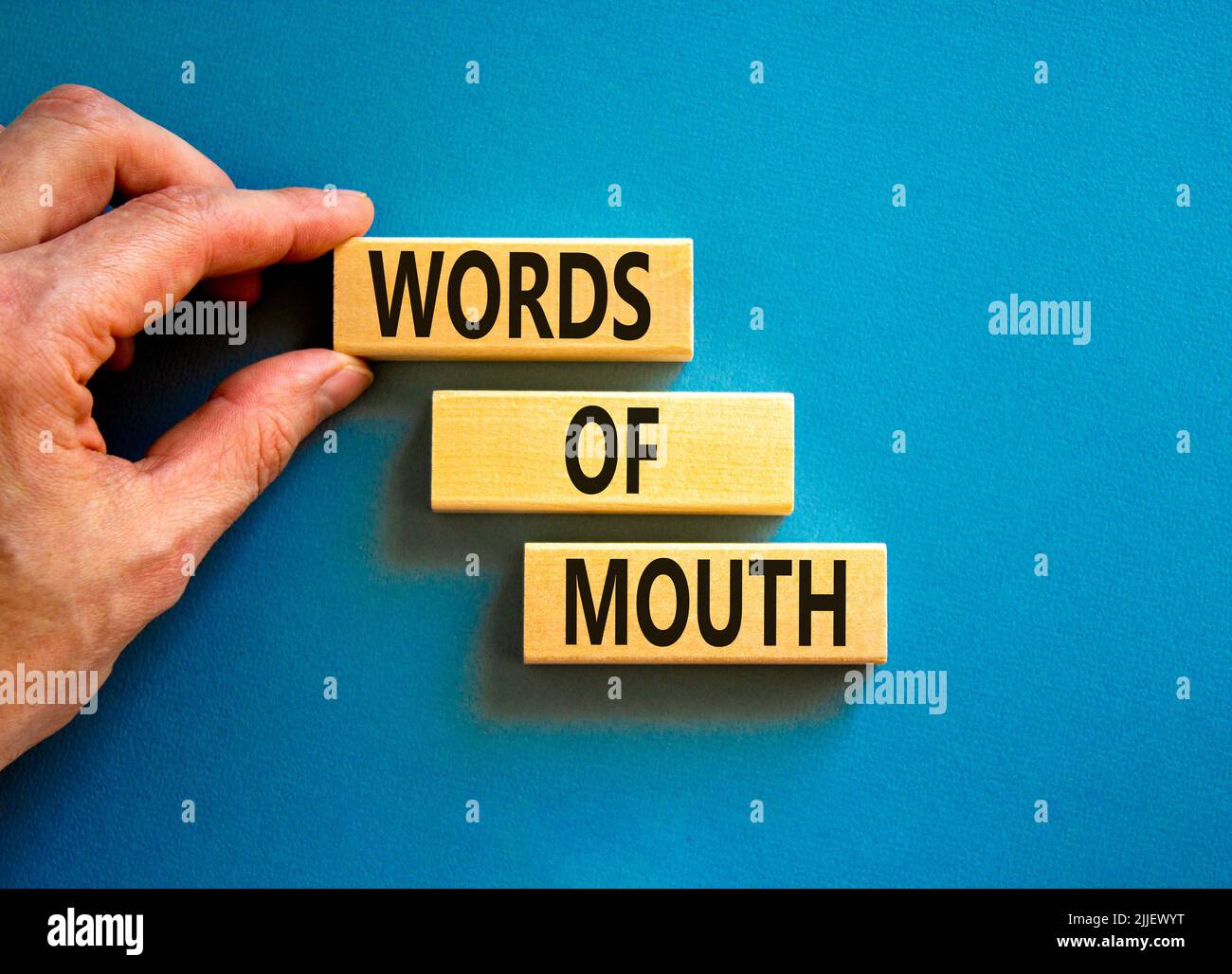 Words of mouth symbol. Concept words Words of mouth on wooden blocks on ...