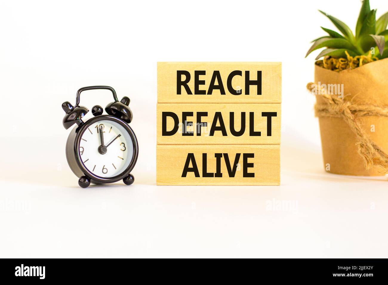 Reach default alive symbol. Concept words Reach default alive on wooden ...
