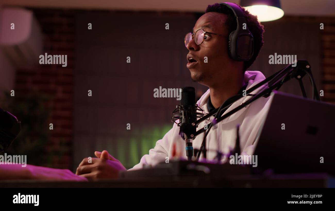 African american online radio presenter talking with influencer guest ...