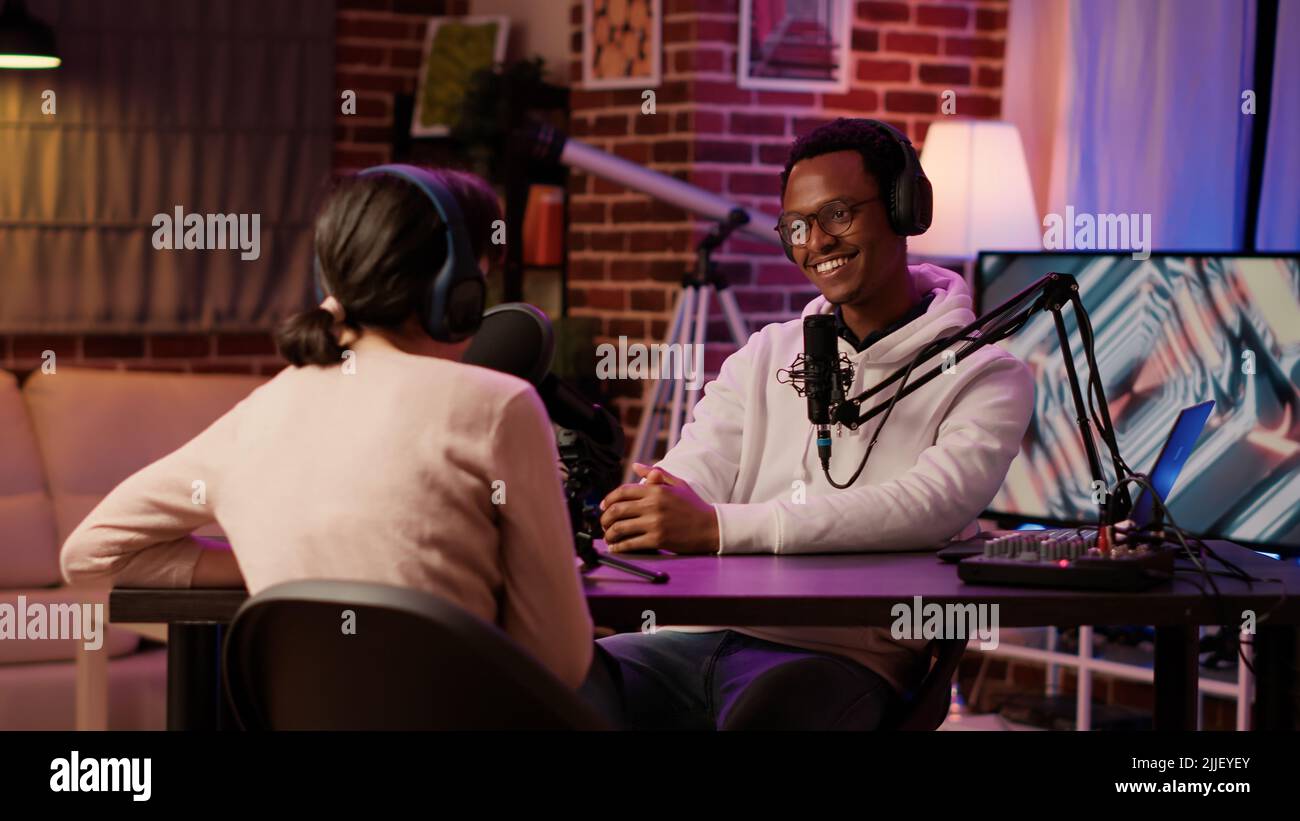 African american podcaster introducing famous influencer to listeners ...