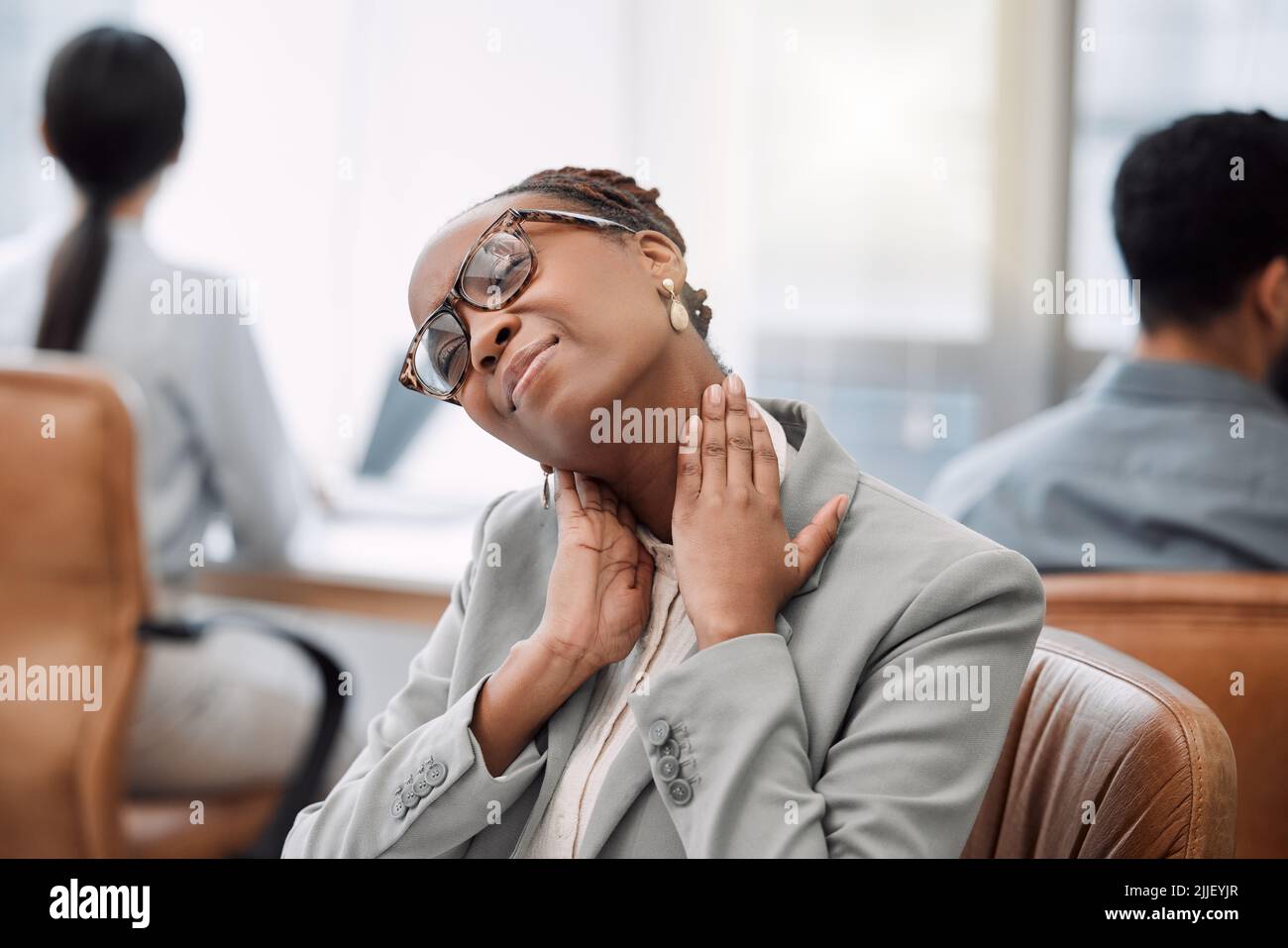 Neck pain can be caused by working in a twisted posture. a young ...