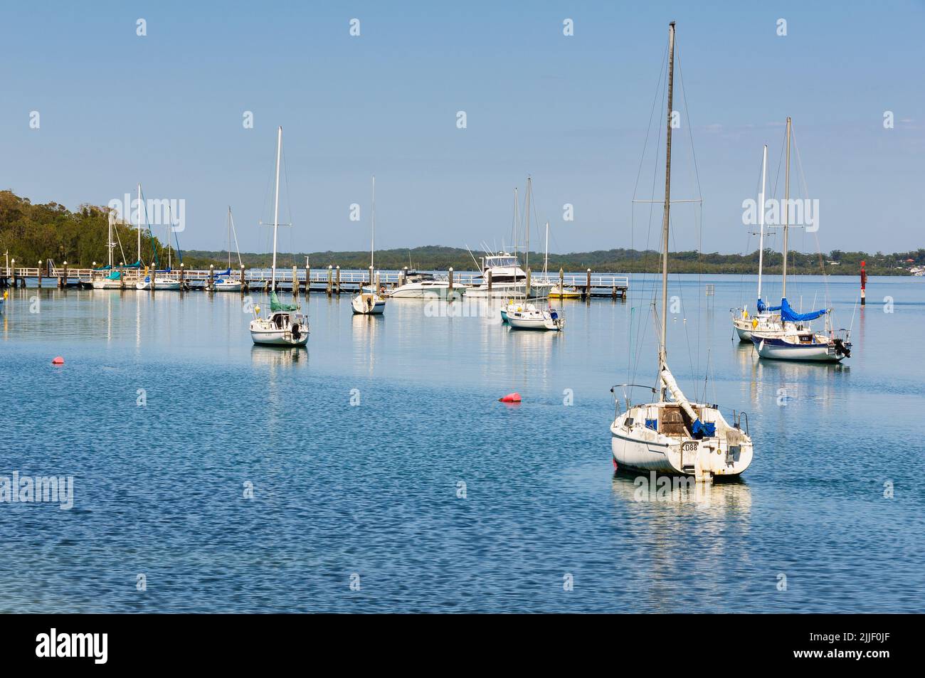 Sailing boats on anchor at Sunset Beach on the peaceful Karuah River ...