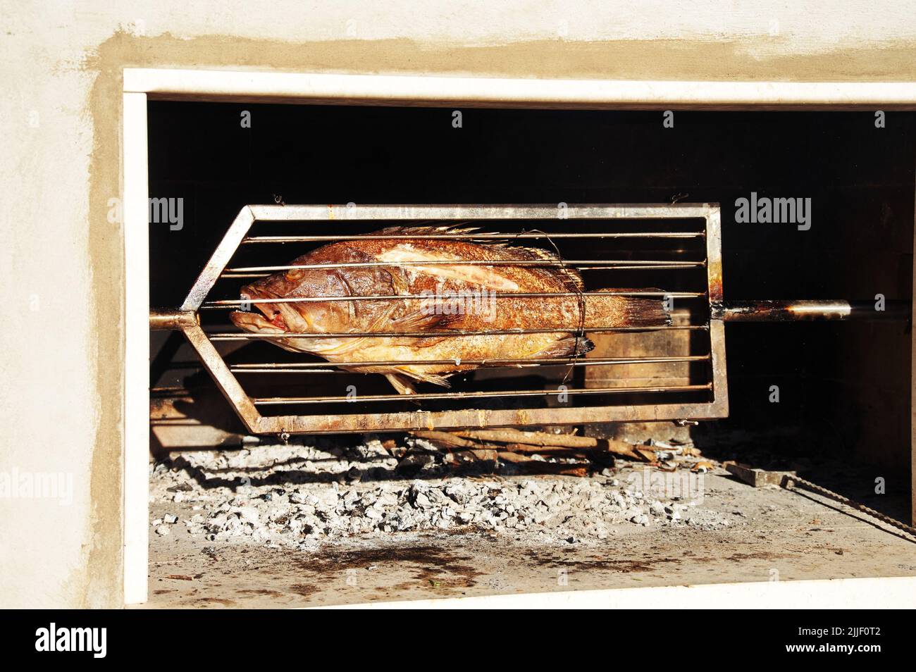 Fish grilling on barbecue grid Stock Photo - Alamy
