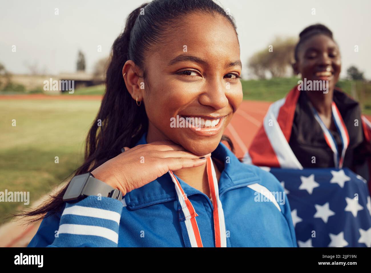 This is the smile of a winner. a young athlete and her teammate Stock ...