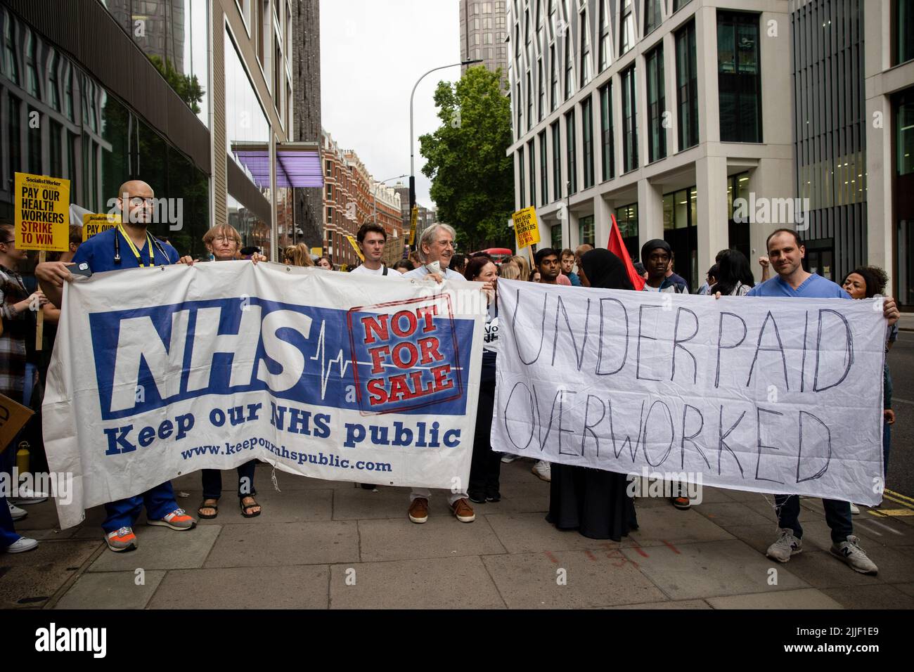 Healthcare professionals including doctors and nurses seen holding ...