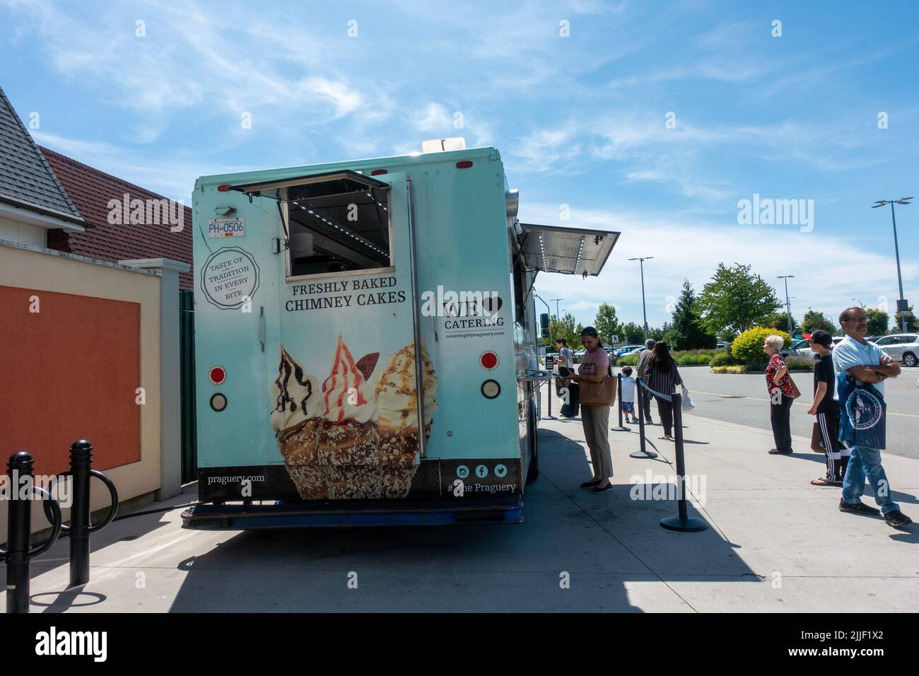 People is line up to get freshly baked chimney cakes dessert food truck ...