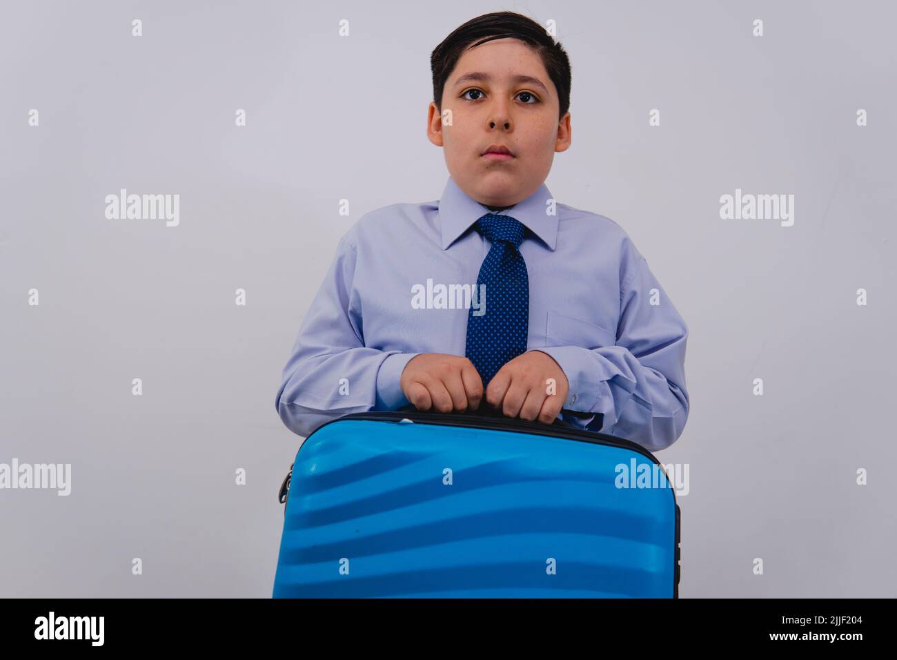 Child dressed in a suit and tie as an executive or businessman with a ...