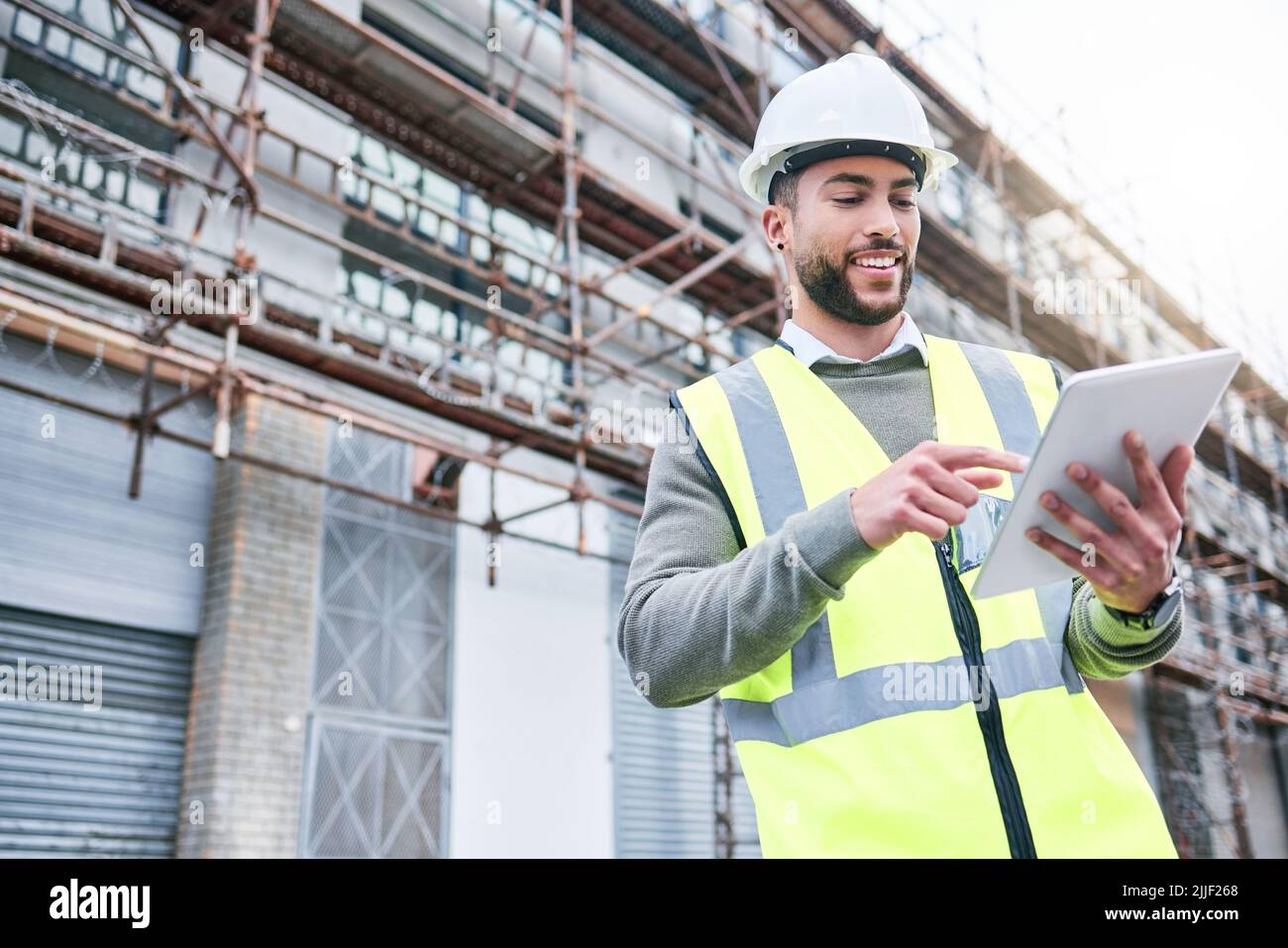 Success is a personal standard. a handsome male construction worker ...