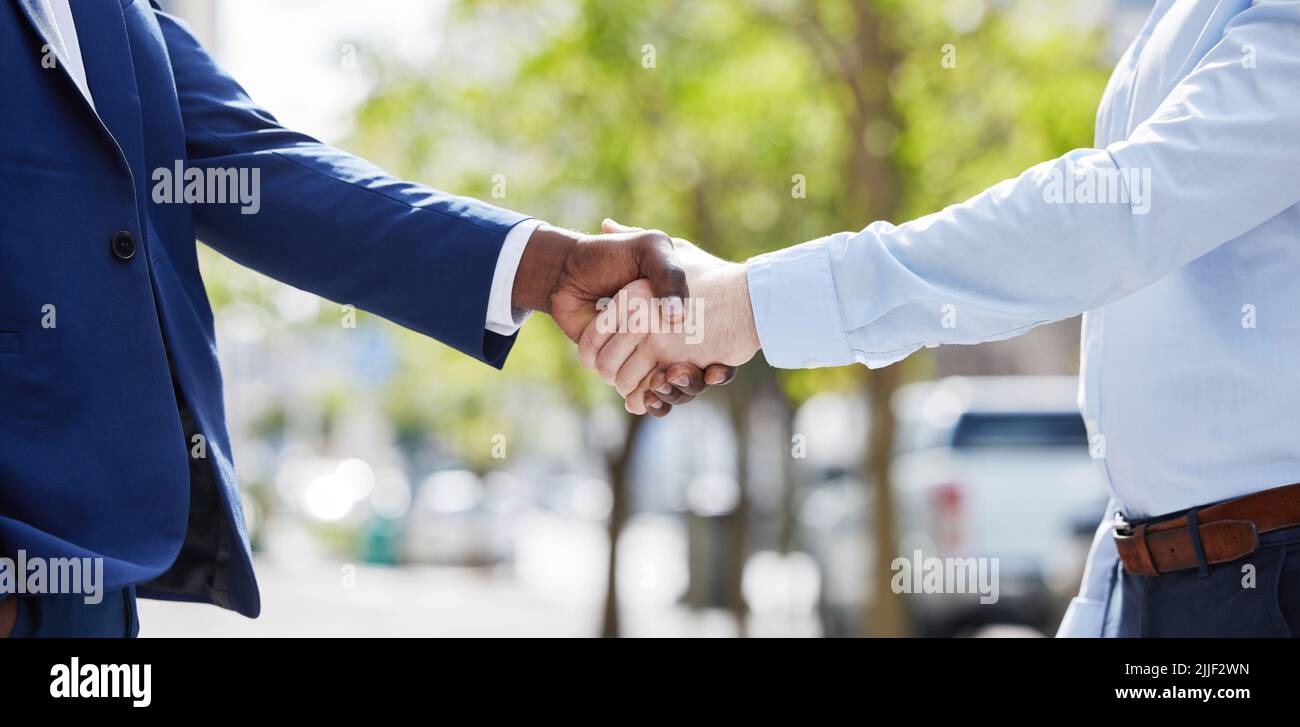No ordinary deal. two unrecognizable businesspeople sharing a handshake ...