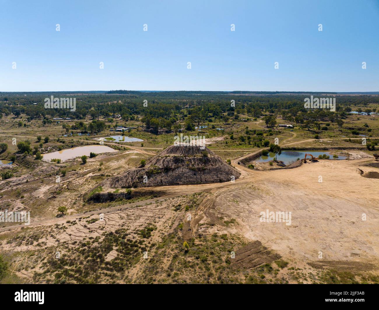 Machinery working industrial sapphire mine site at Rubyvale in Central ...