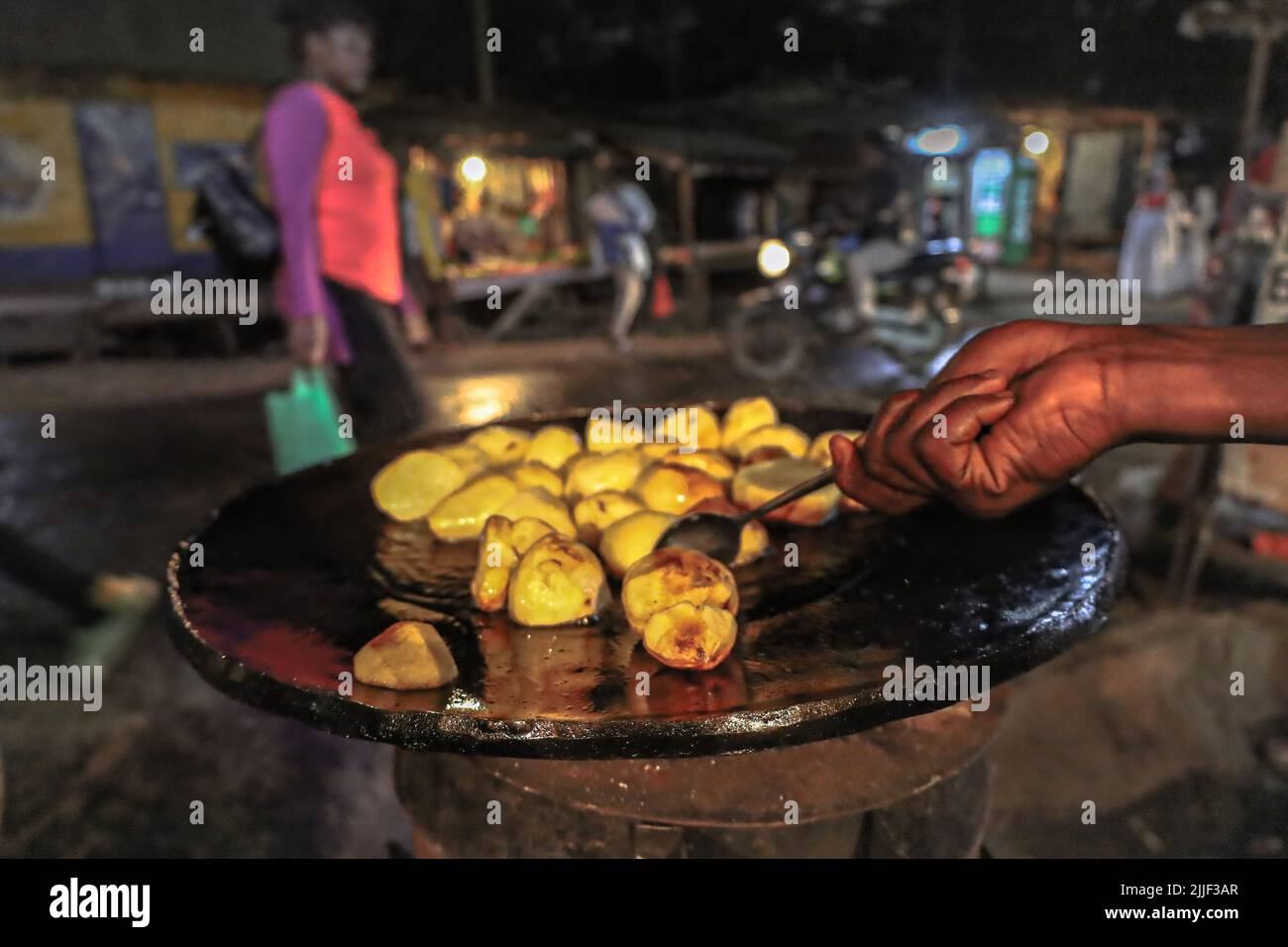 Potatoes are prepared outside a local street restaurant in Kibera Slum ...
