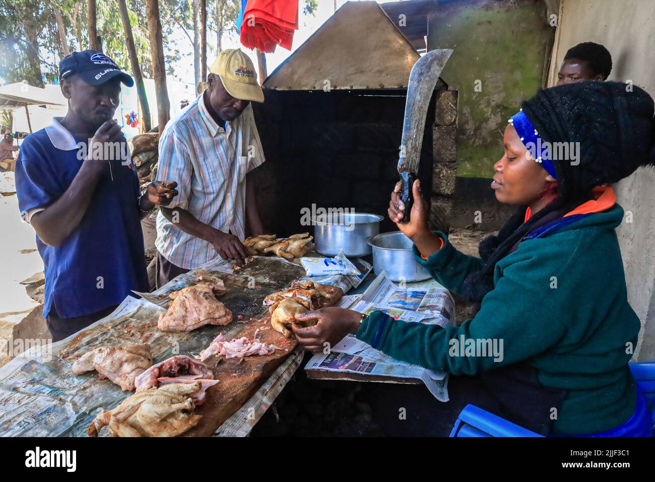 Millicent Awuor, a business woman sells deep fried chicken to locals at ...
