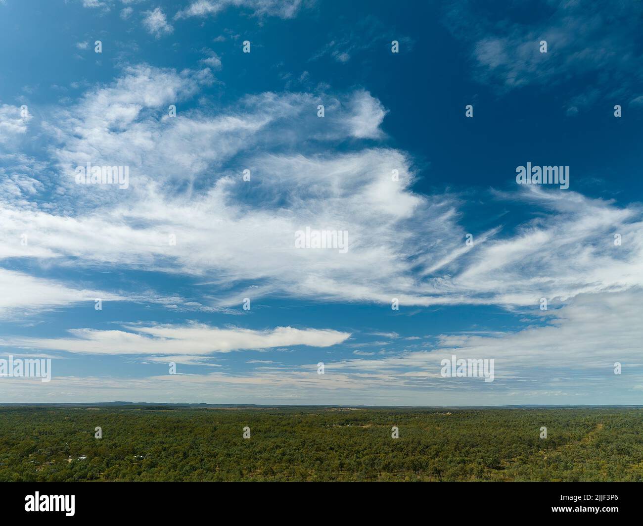The vastness of the Australian bush under a cloudy blue sky Stock Photo ...
