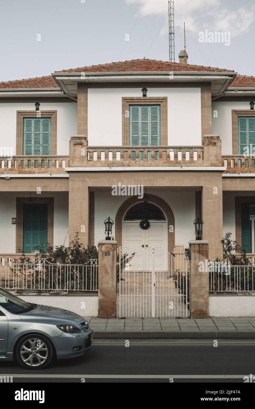 Modern building with columns, balcony and tropical plants in Larnaca ...