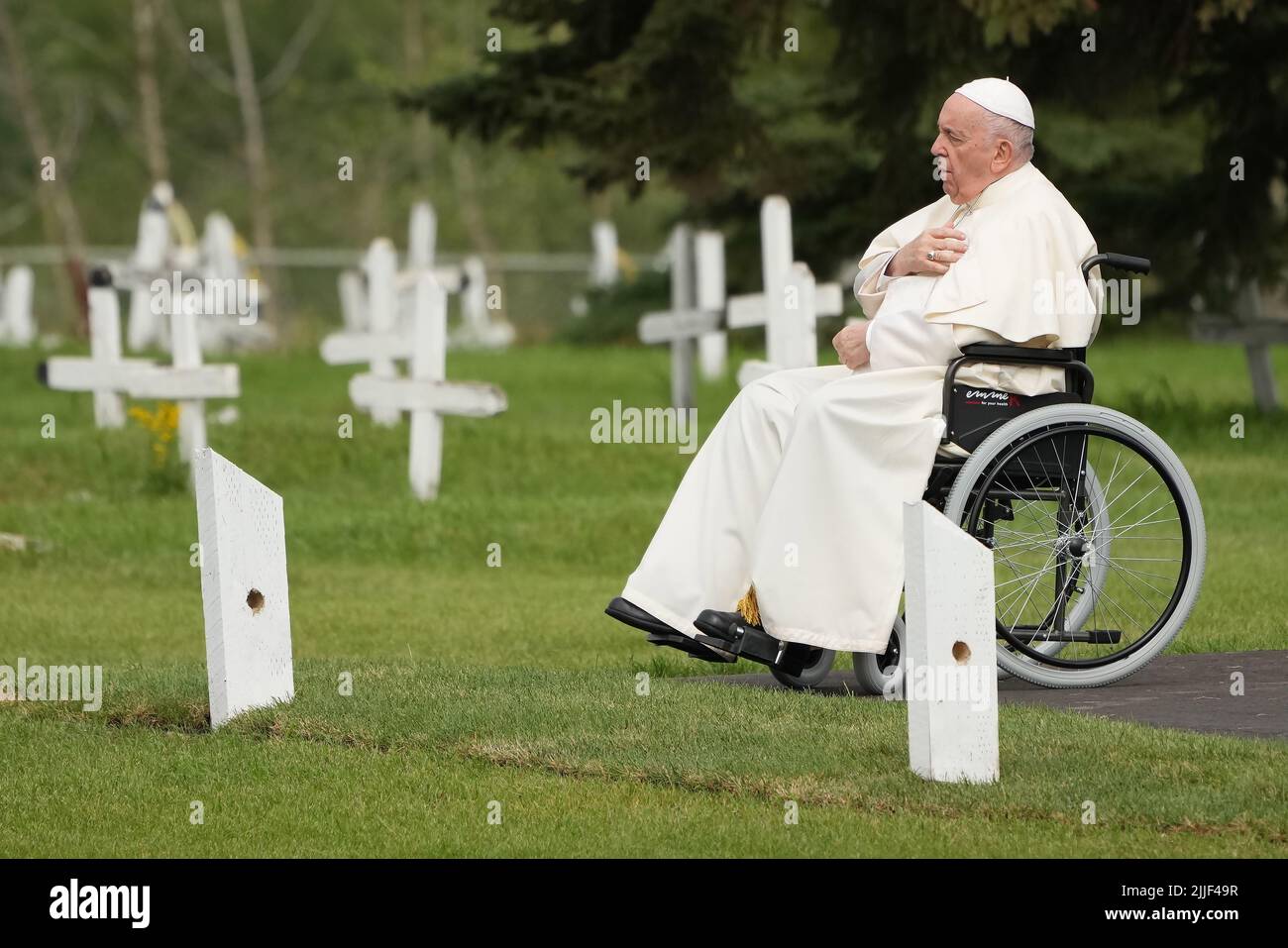 Pope Francis prays at a gravesite at the Ermineskin Cree Nation ...