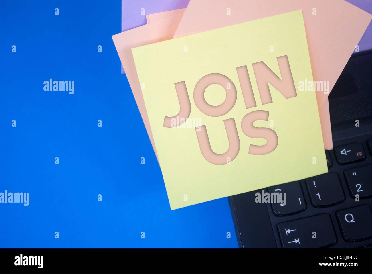 Join Us. Text on adhesive note paper. Event, celebration reminder ...