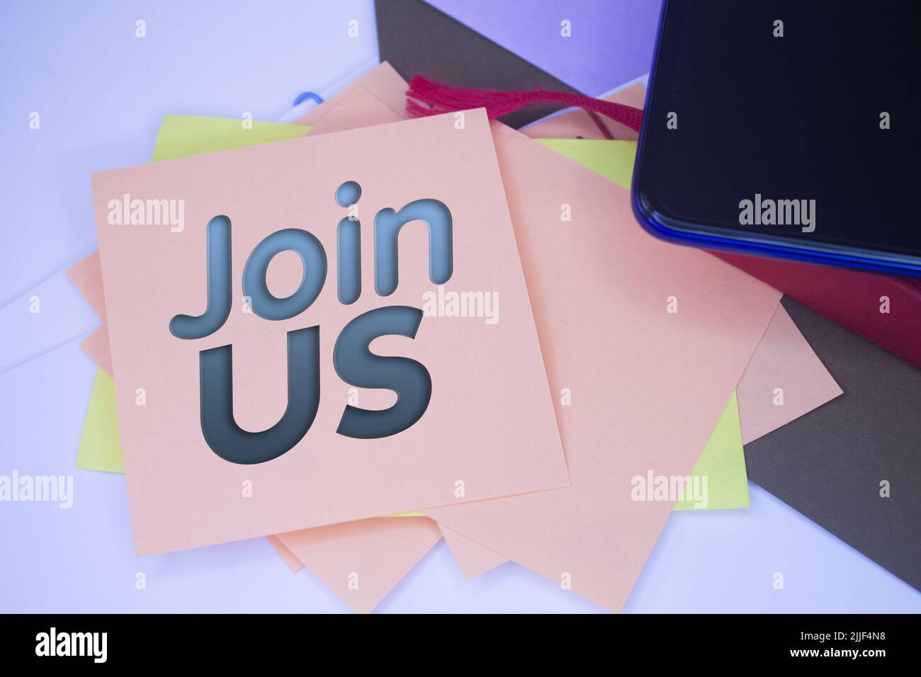 Join Us. Text on adhesive note paper. Event, celebration reminder ...