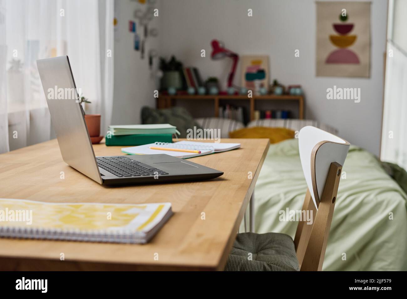 Horizontal image of table with laptop for online education in bedroom ...