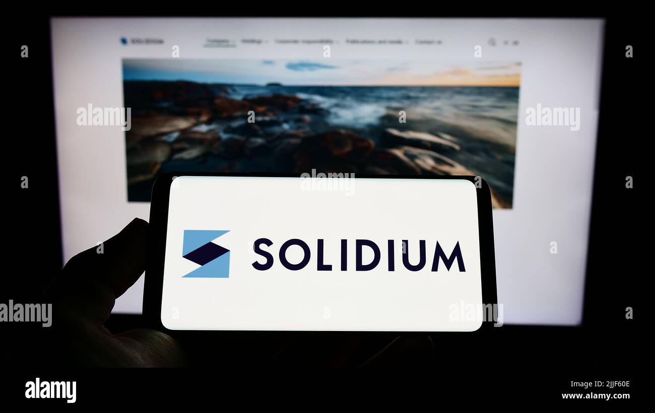 Person holding mobile phone with logo of Finnish investment company ...