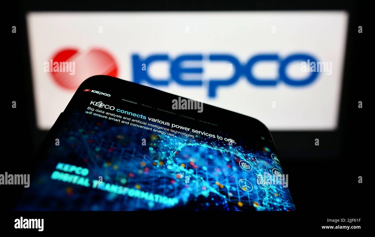 Mobile phone with website of Korea Electric Power Corporation (KEPCO) on screen in front of ...