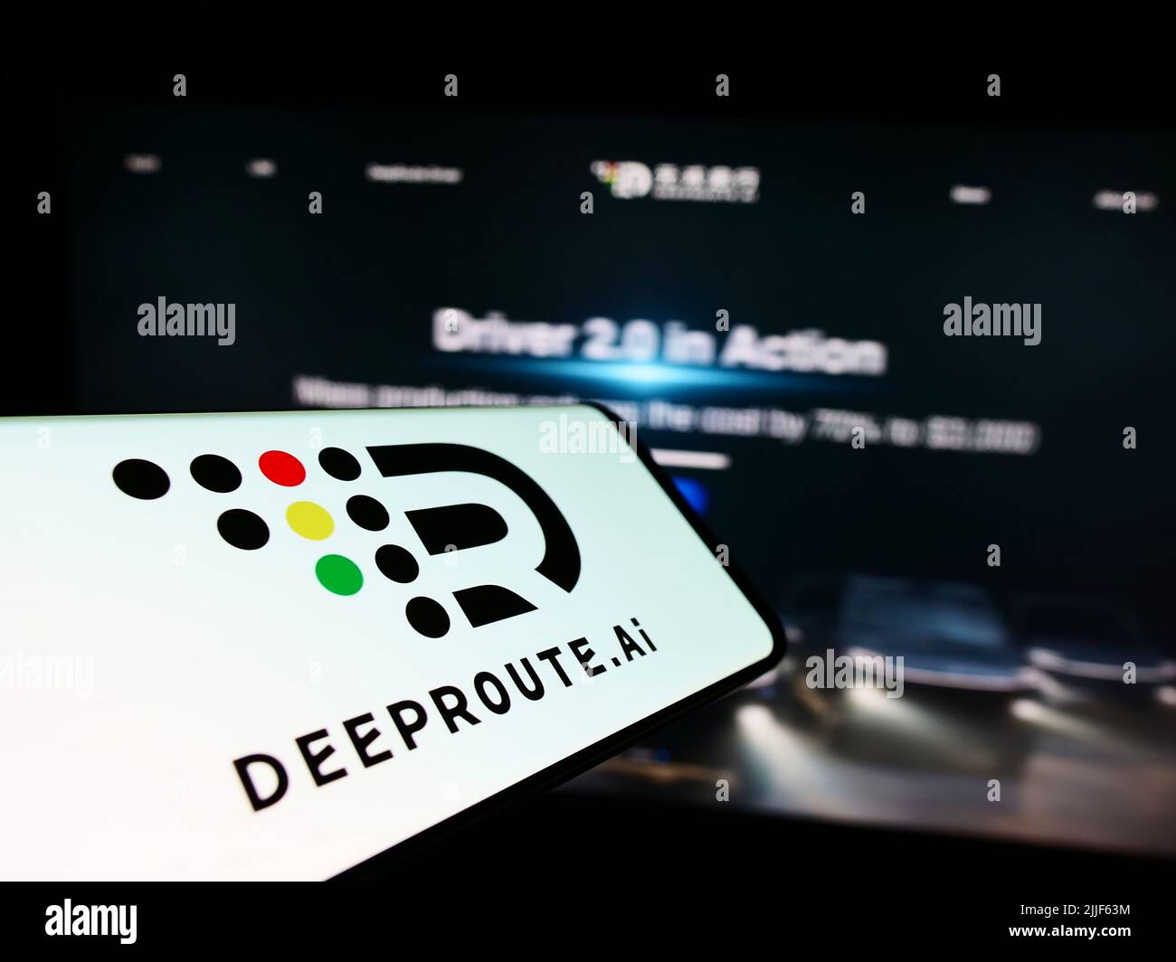 Cellphone with logo of Chinese company Shenzhen Deeproute.ai Co. Ltd. on screen in front of ...