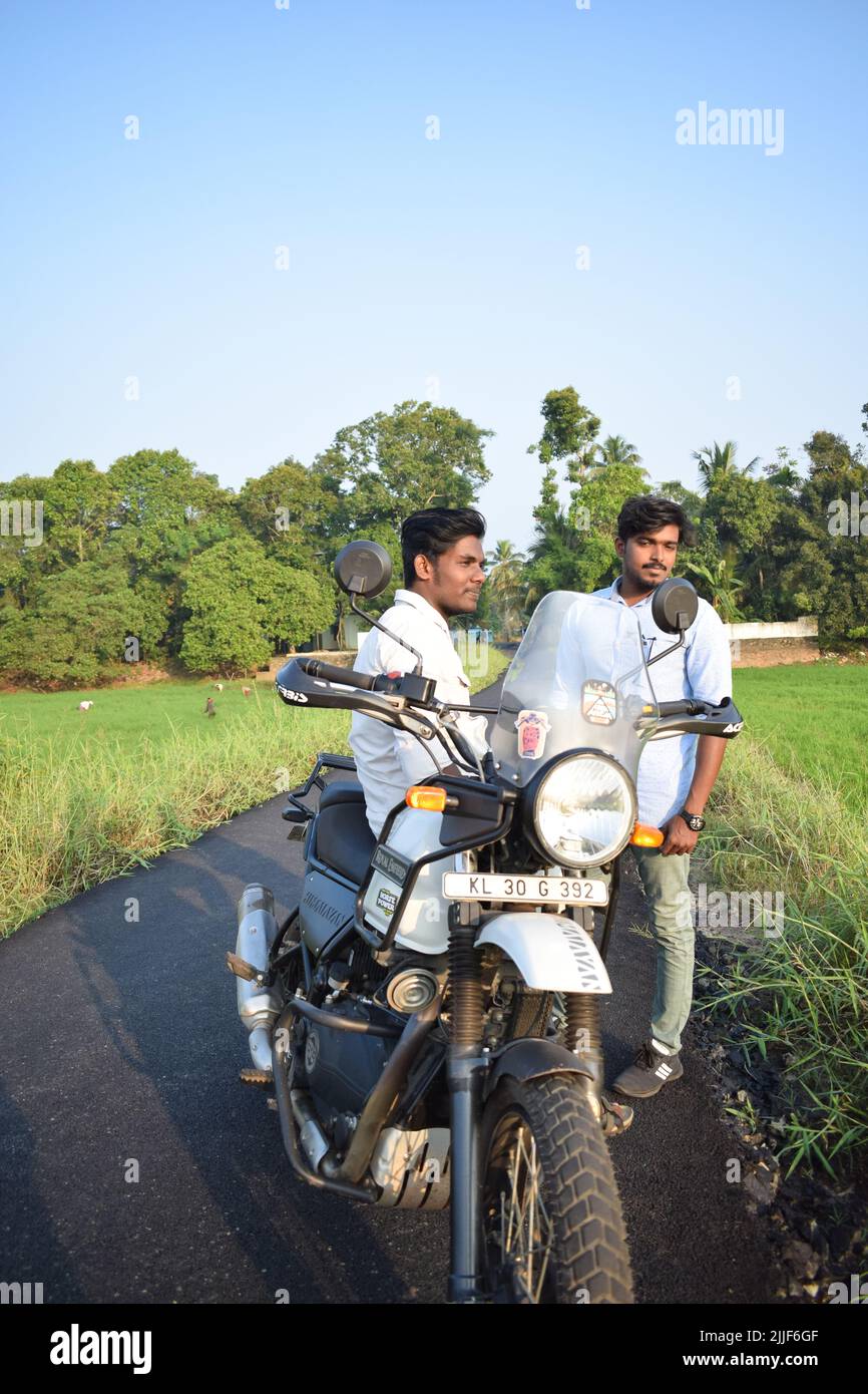 An Indian man sitting on a motorbike and posing for photo Stock Photo ...