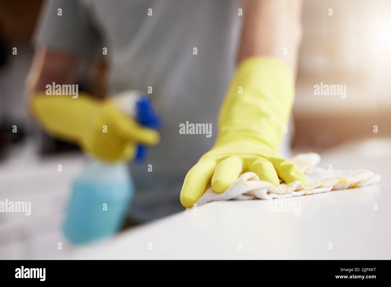 Cleaning these counters. an unrecognizable man cleaning a counter at ...
